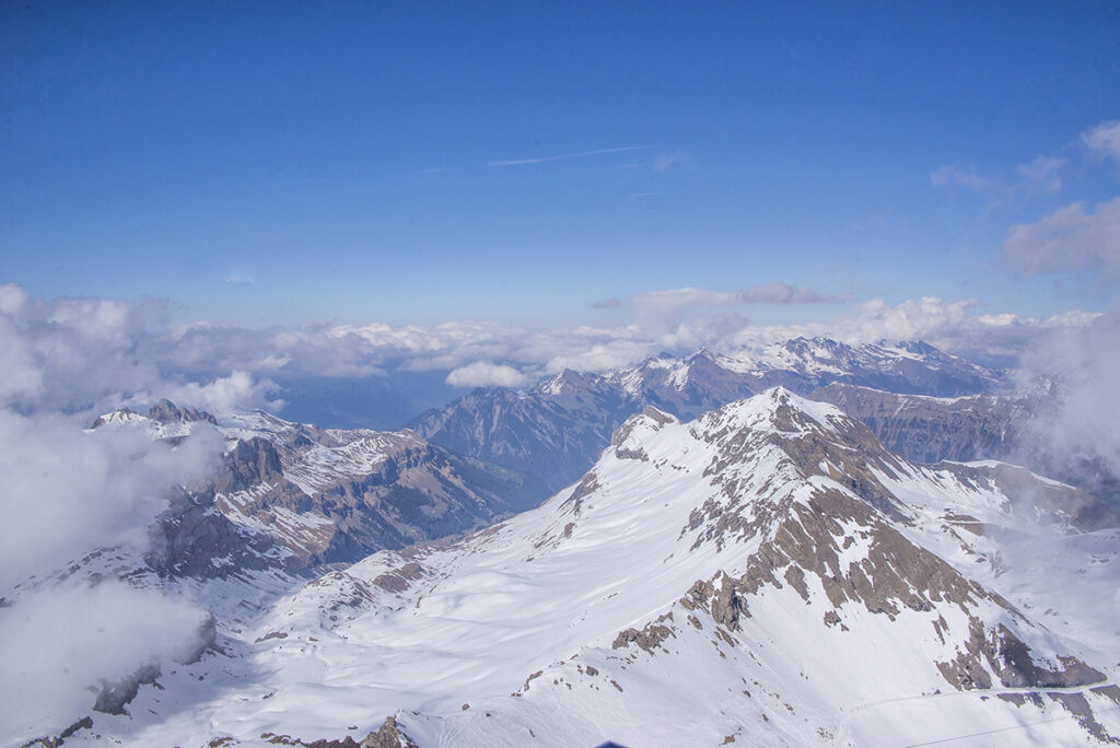 A snowy mountain tops with clouds in the sky - Magicdecor®