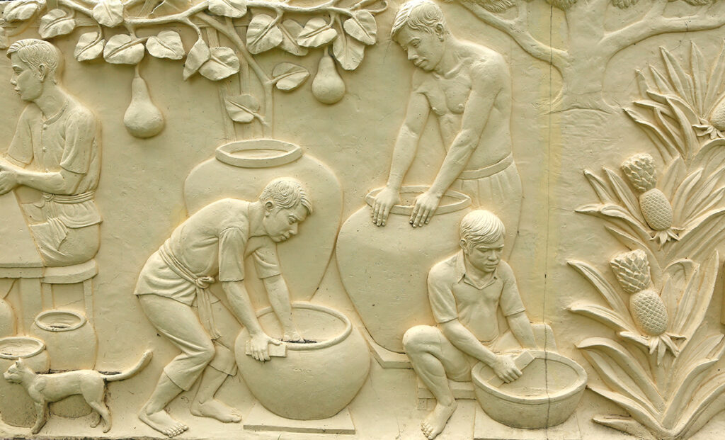 A stone carving of men working in pots - Magicdecor®